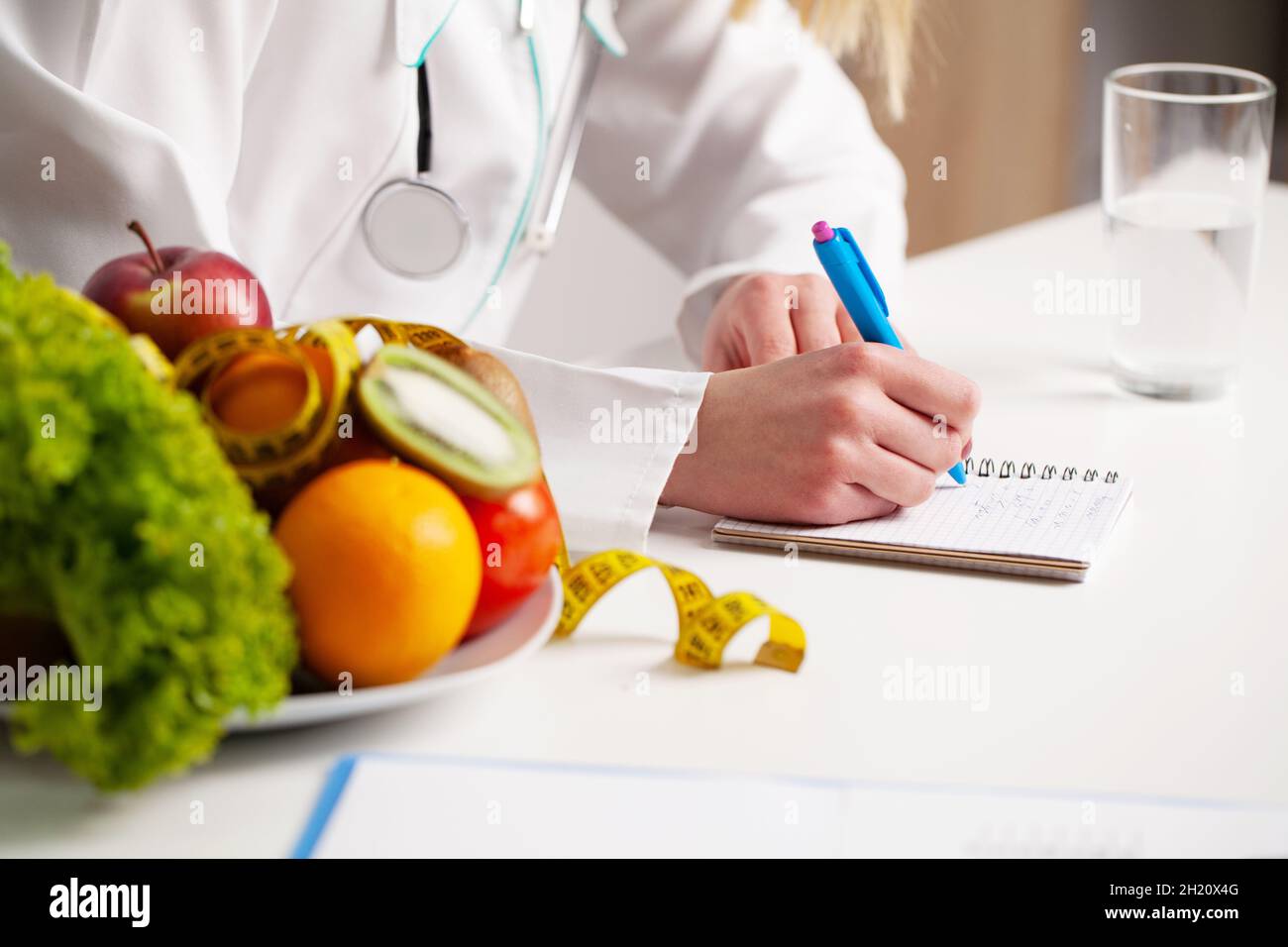 Nutritionist prepares a diet plan for an overweight woman Stock Photo ...