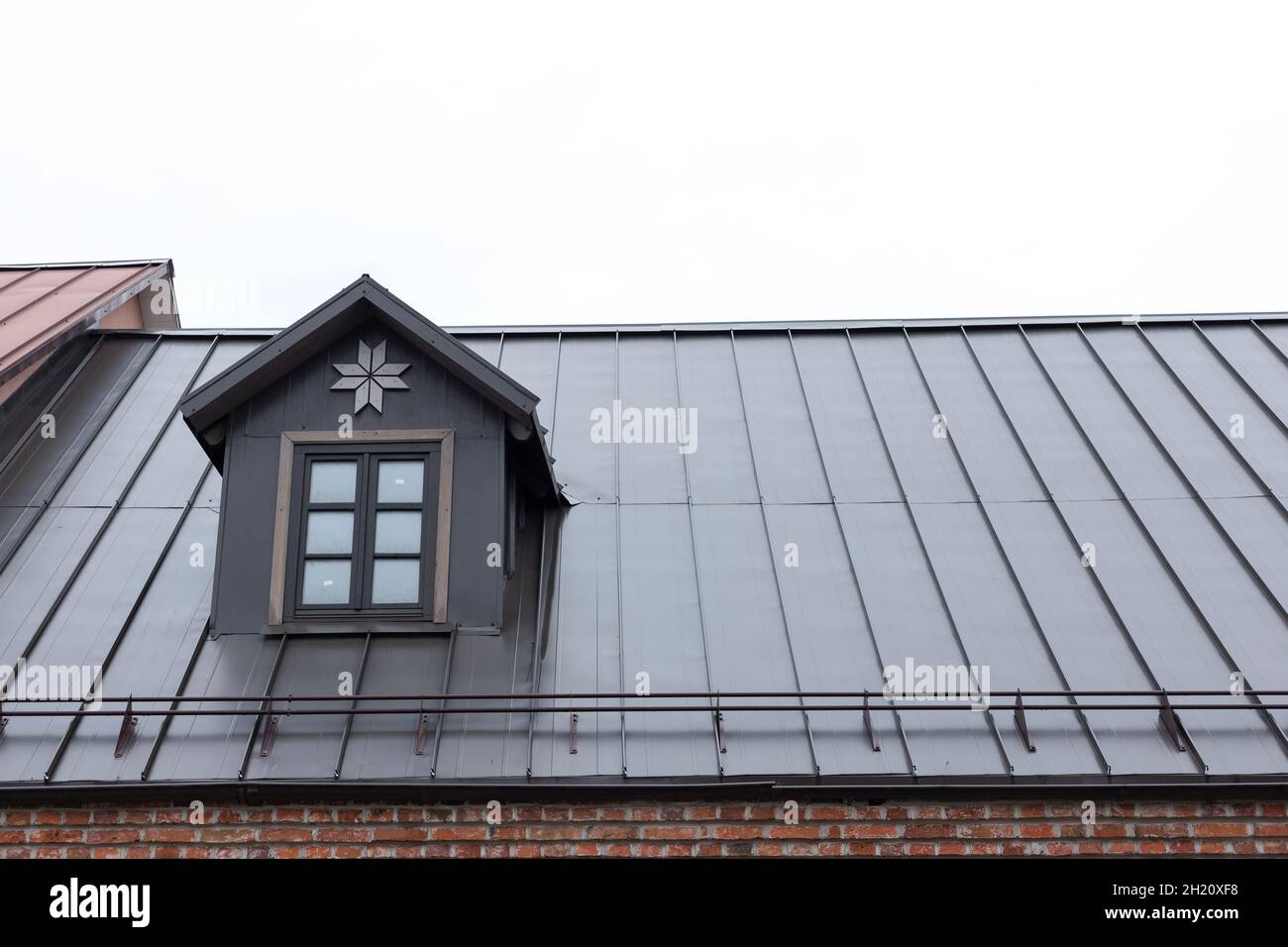 Attic window on the roof of the house Stock Photo - Alamy