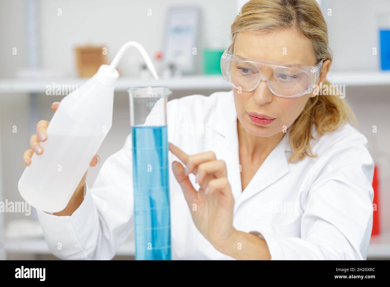 Female chemist studying test tube hi-res stock photography and images ...