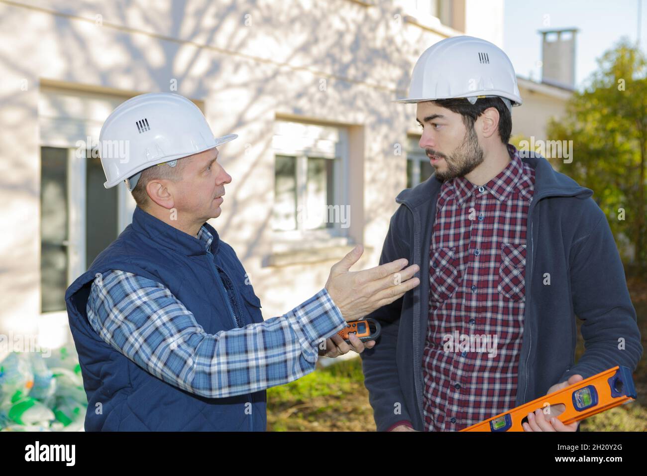 photo of two builders at construction site Stock Photo - Alamy