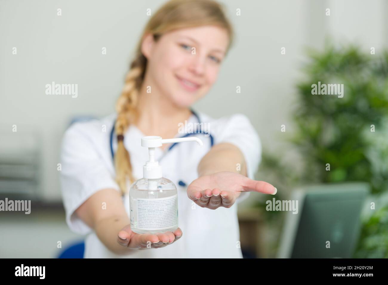 medical worker dispensing antibacterial gel onto hand Stock Photo - Alamy