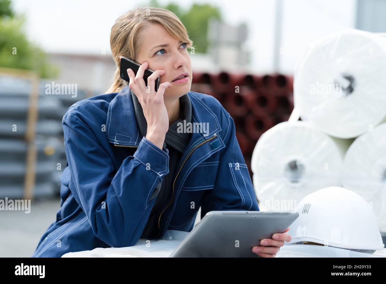female worker on the phone outside warehouse Stock Photo - Alamy