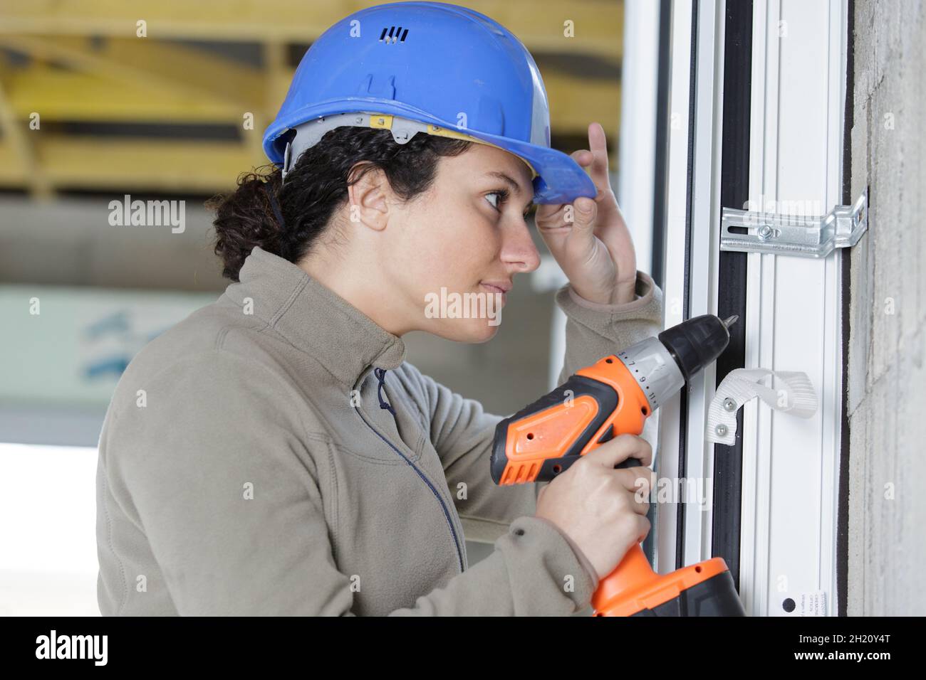 woman is drilling a window or door Stock Photo - Alamy