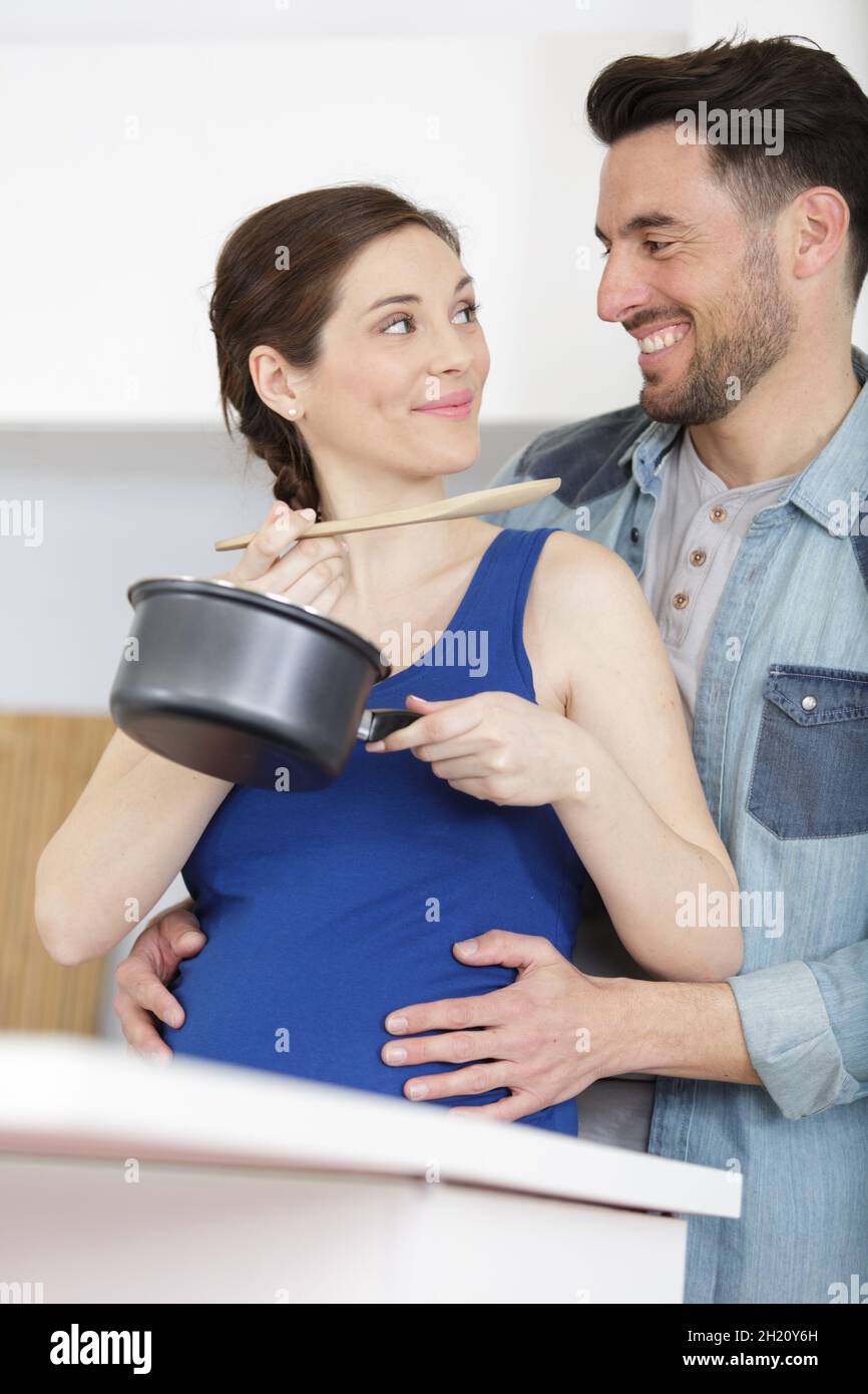 portrait of a young smiling couple tasting food Stock Photo - Alamy