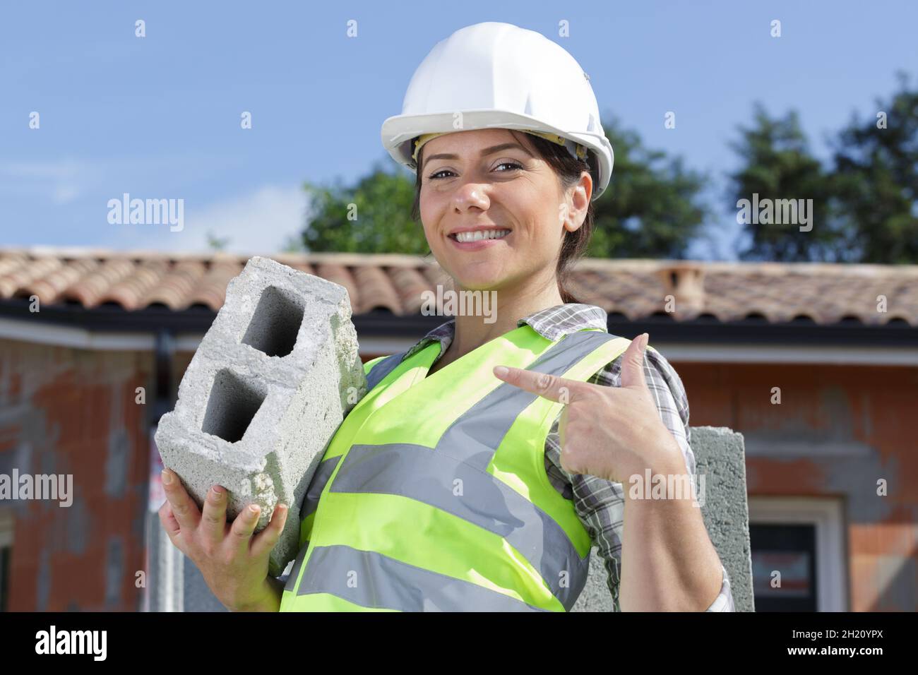 woman builder pointing a brick Stock Photo - Alamy