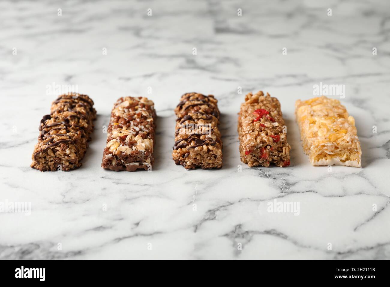 Tasty protein bars on marble table. Healthy snack Stock Photo - Alamy