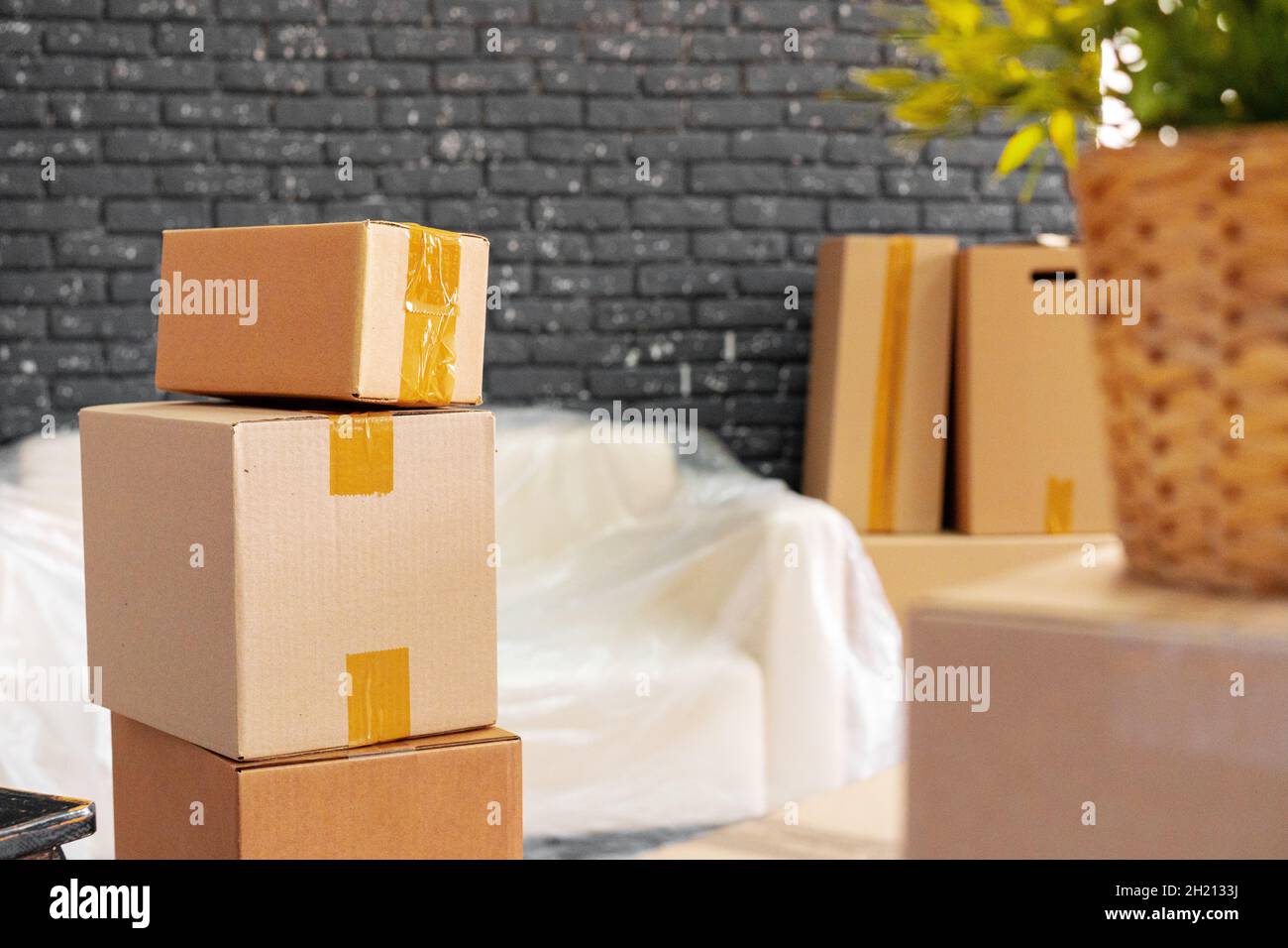 Moving in or moving out concept. Stack of boxes and packed furniture ...