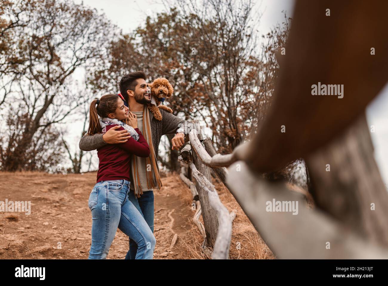 Couple standing at viewpoint and hugging. Man holding on his shoulder ...