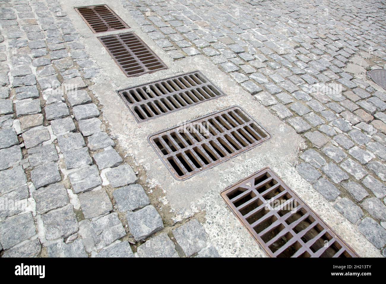cobbleston granite stone road with drainage grates for storm water ...