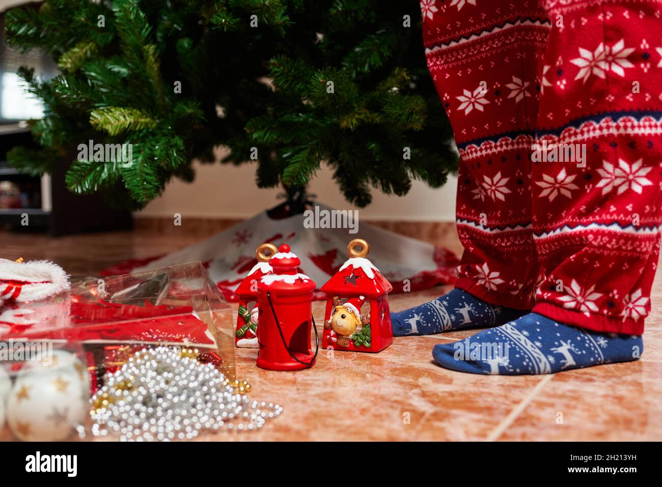 Preparing the Christmas tree with decoration on the floor Stock Photo ...