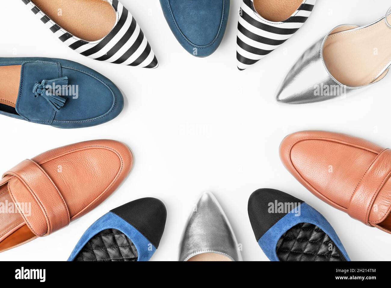 Different female shoes on white background, top view Stock Photo - Alamy