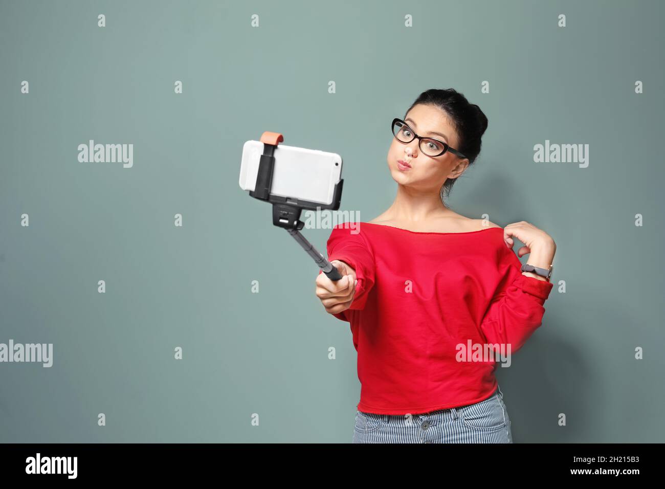 Attractive young woman taking selfie on grey background Stock Photo - Alamy