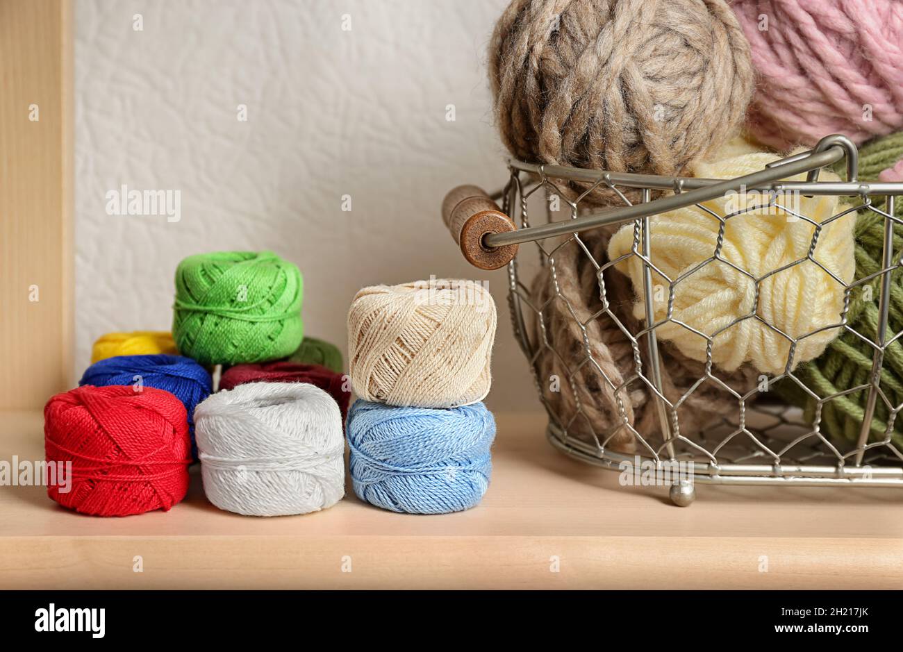 Set of color threads on wooden shelf Stock Photo - Alamy