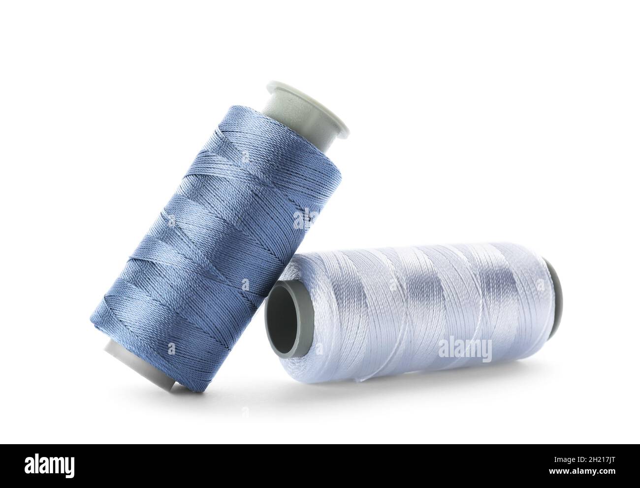 Color sewing threads on white background Stock Photo - Alamy