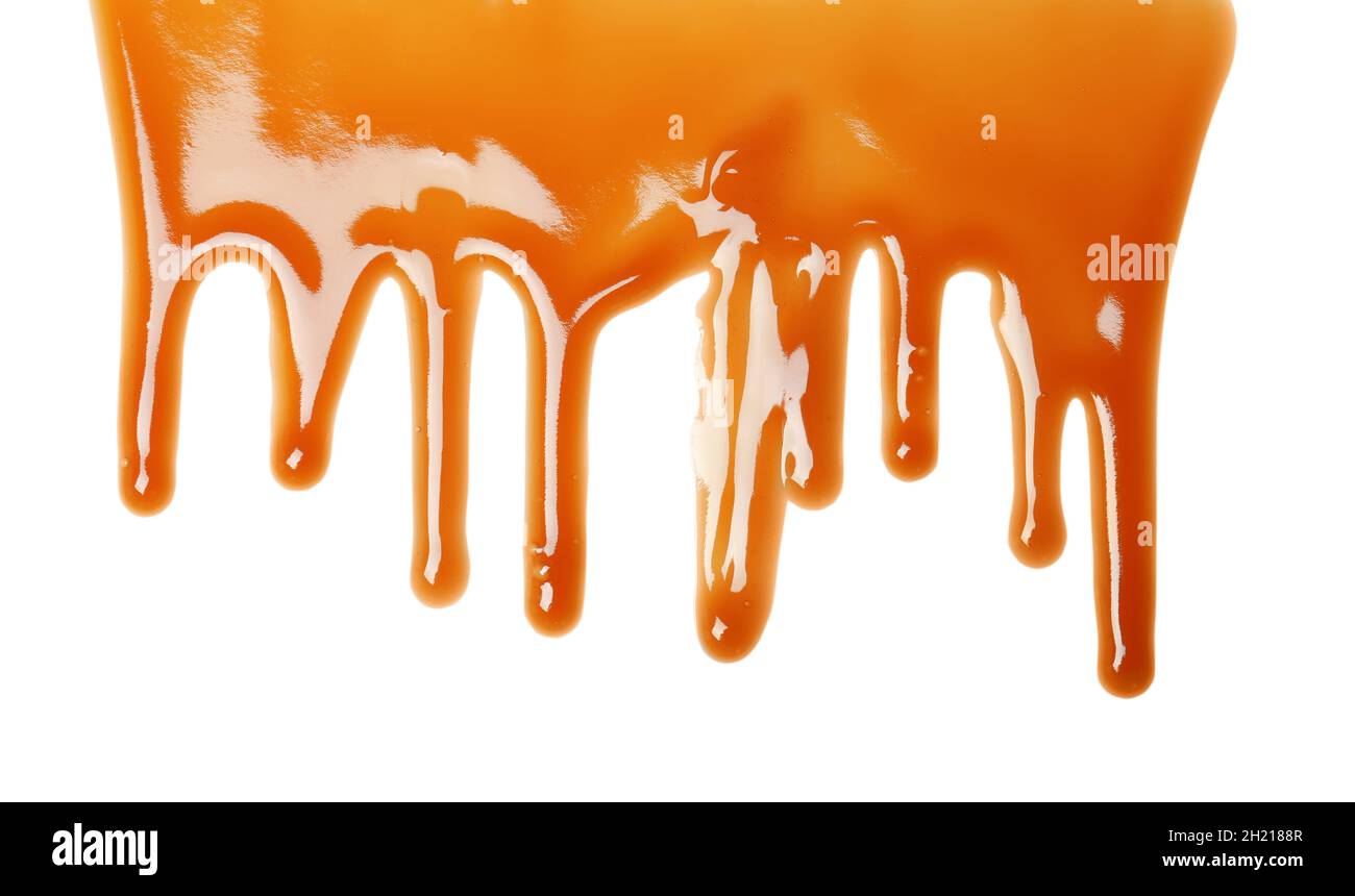 Delicious caramel sauce on white background Stock Photo - Alamy