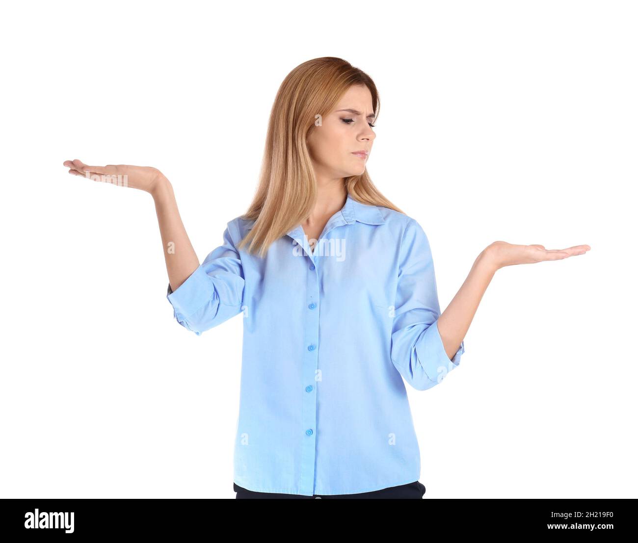 Portrait of businesswoman showing balance gesture on white background ...
