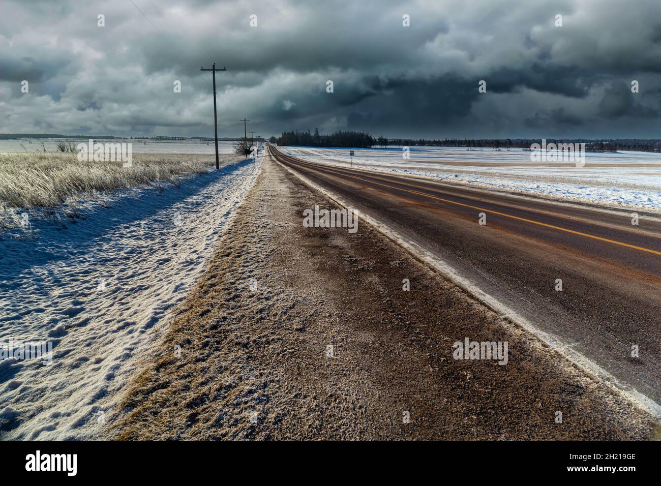 Asphalt highway traveling through a winter landscape Stock Photo - Alamy