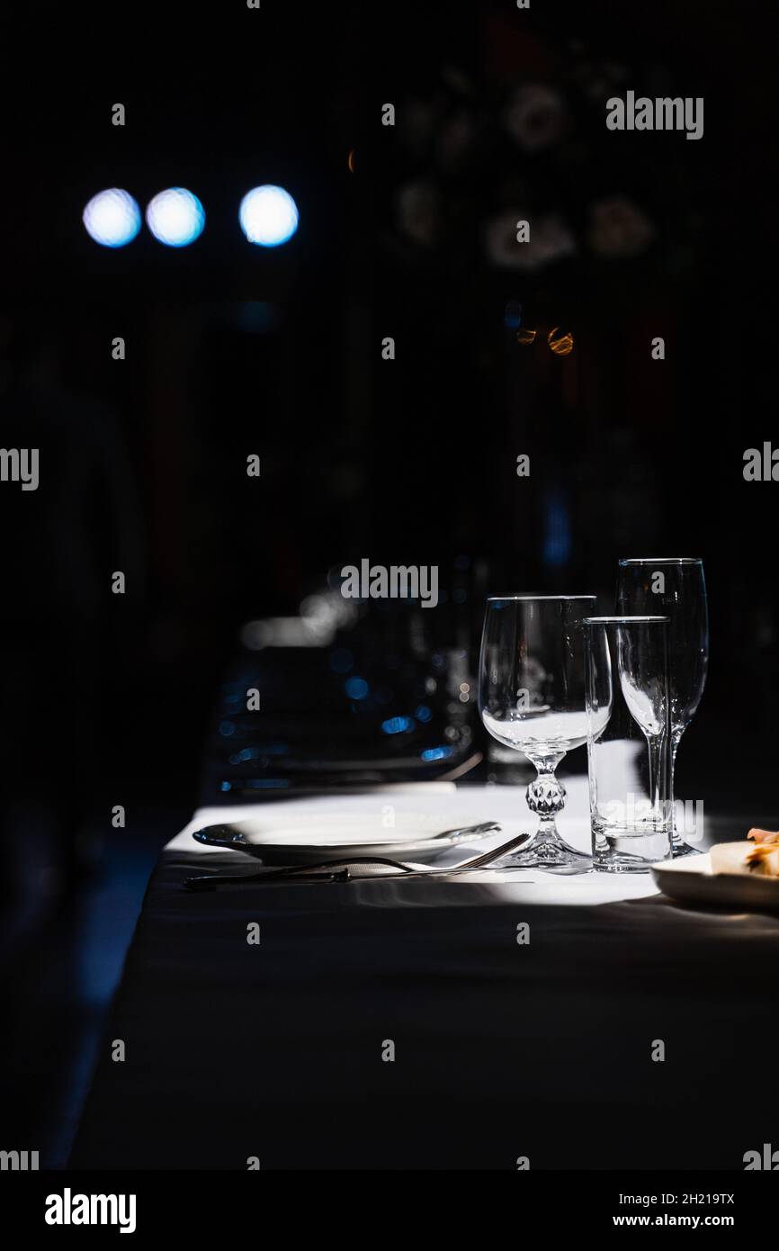 Glasses, plate and cutlery on the table. Table setting in the ...