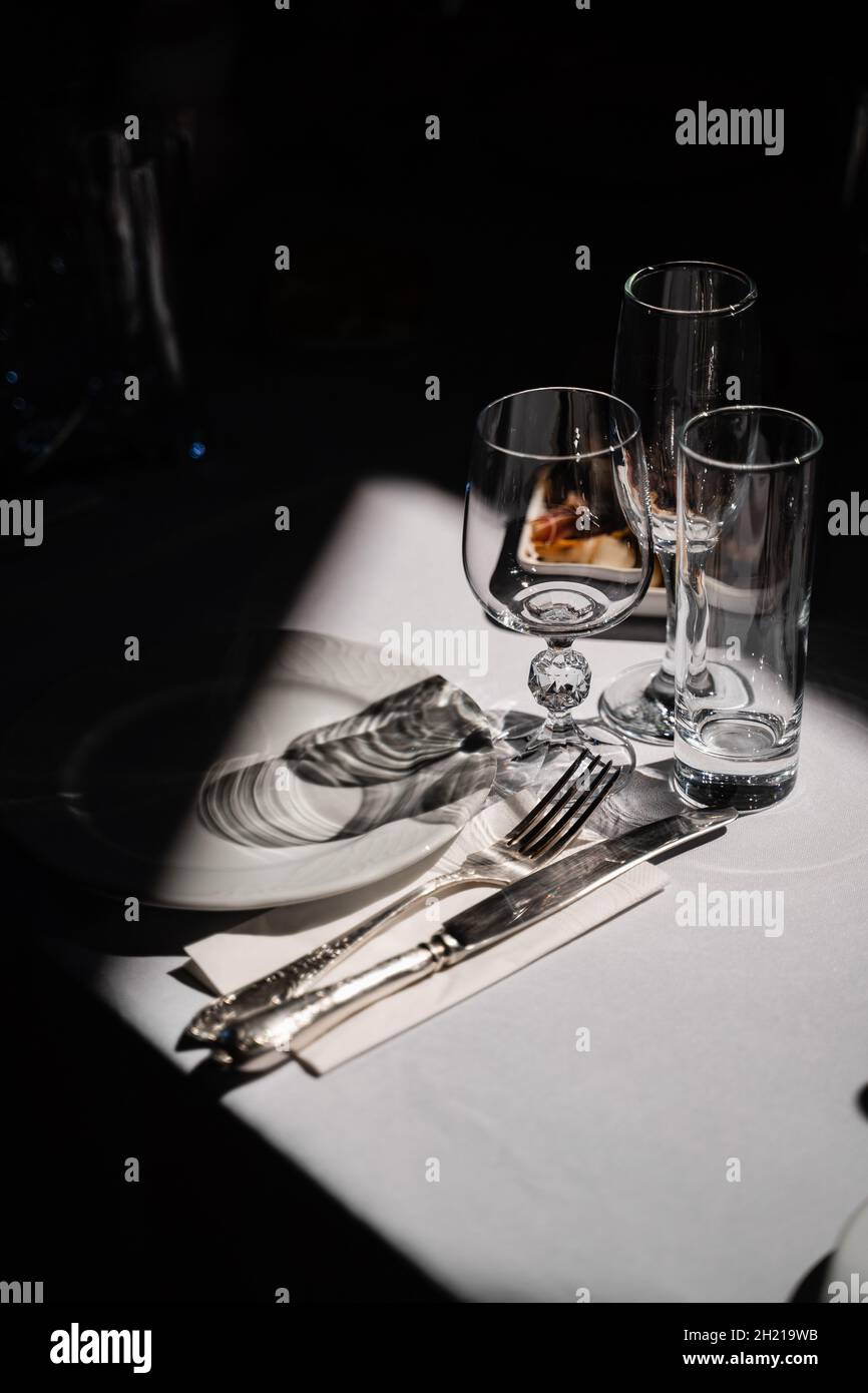 Glasses, plate and cutlery on the table. Table setting in the ...