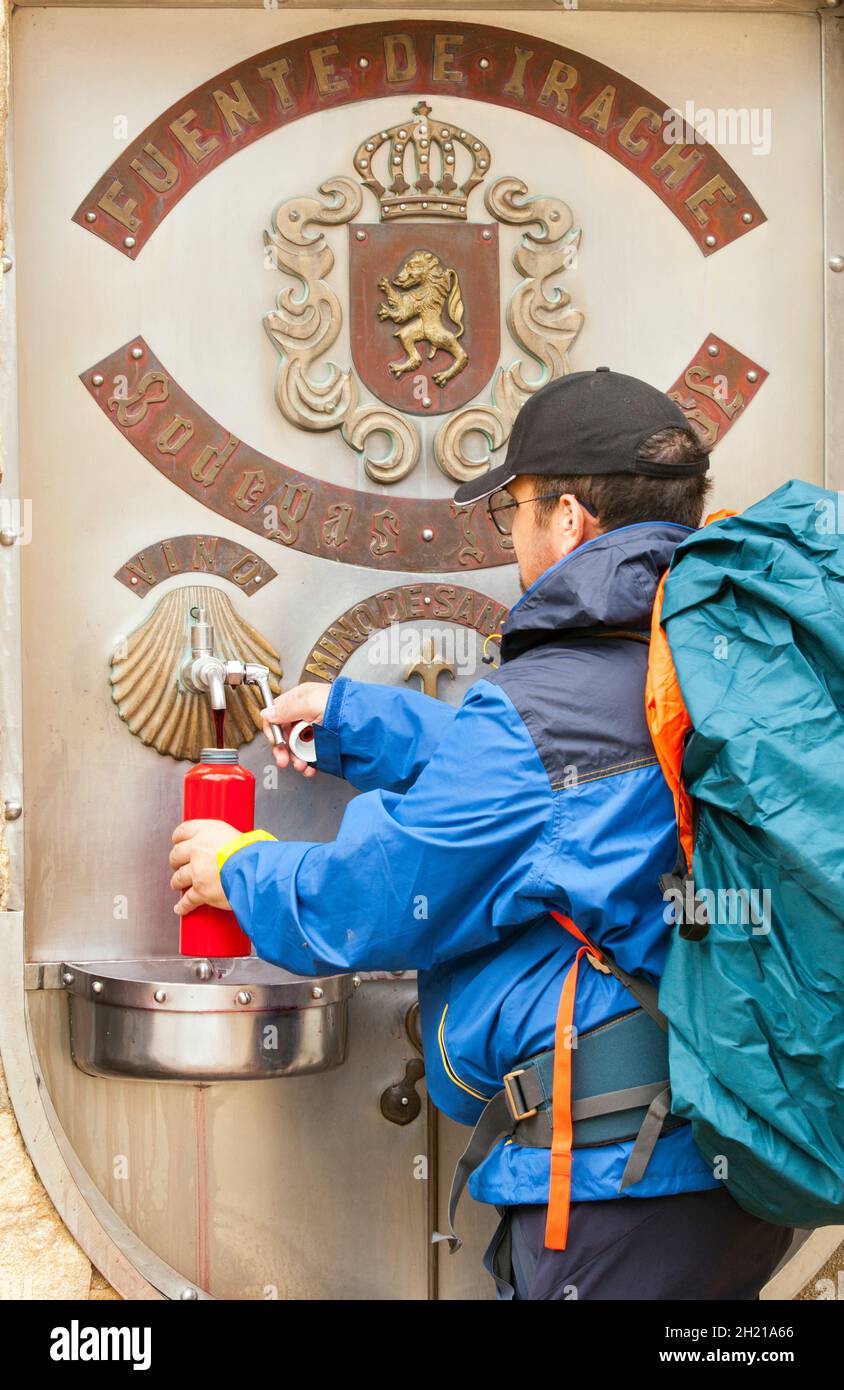 Pilgrims using the wine fountain at the Bodegas Irache at Ayegui Navarra while walking the ...