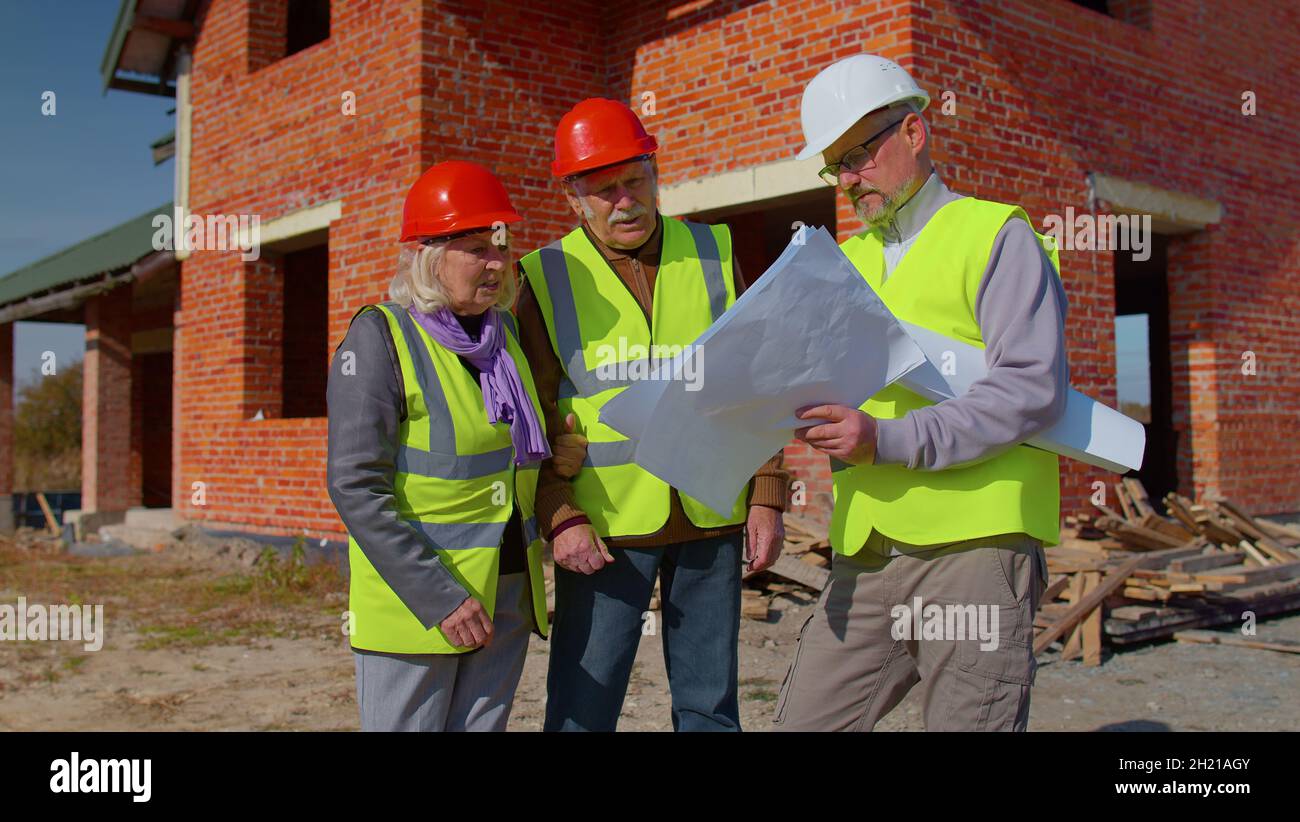 Architect with senior civil engineers discussing project work with ...