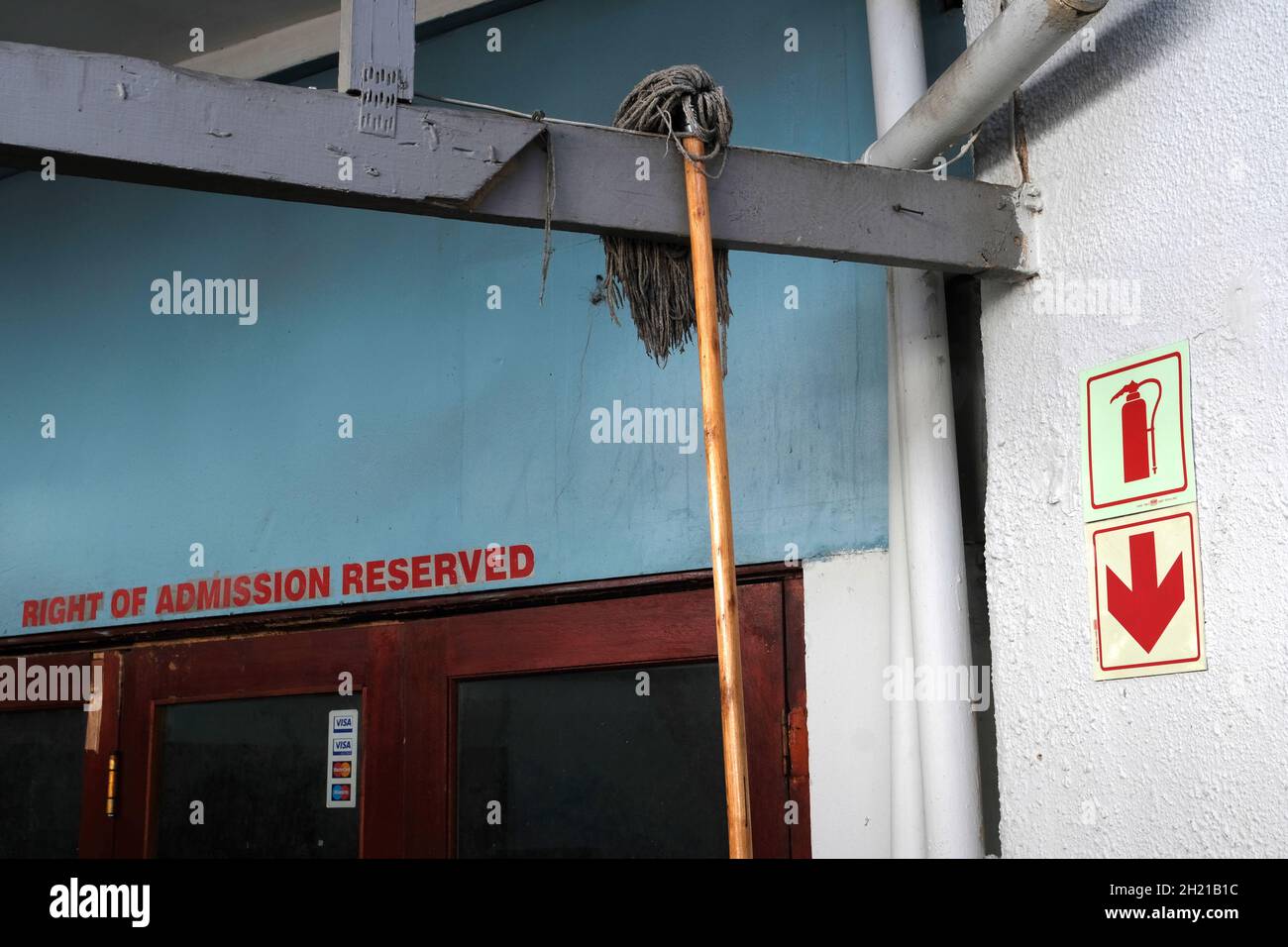 A wet and dirty cleaning mop hooked on a truss beam inside a local ...