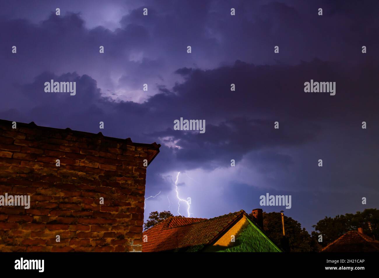 Building under the lightning sky background Stock Photo - Alamy