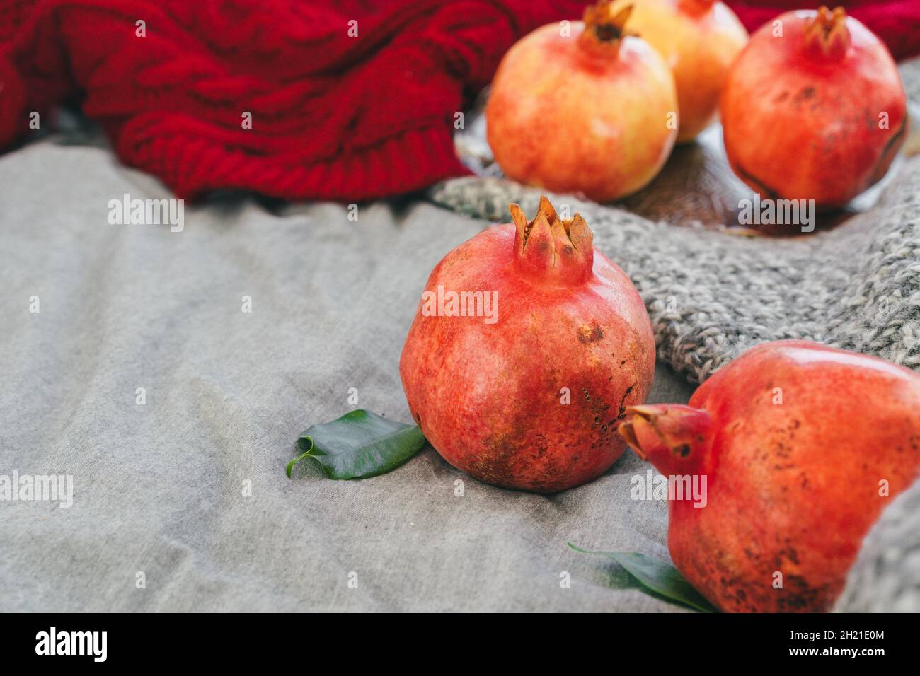 Pomegranate on a gray plaid close up Stock Photo - Alamy