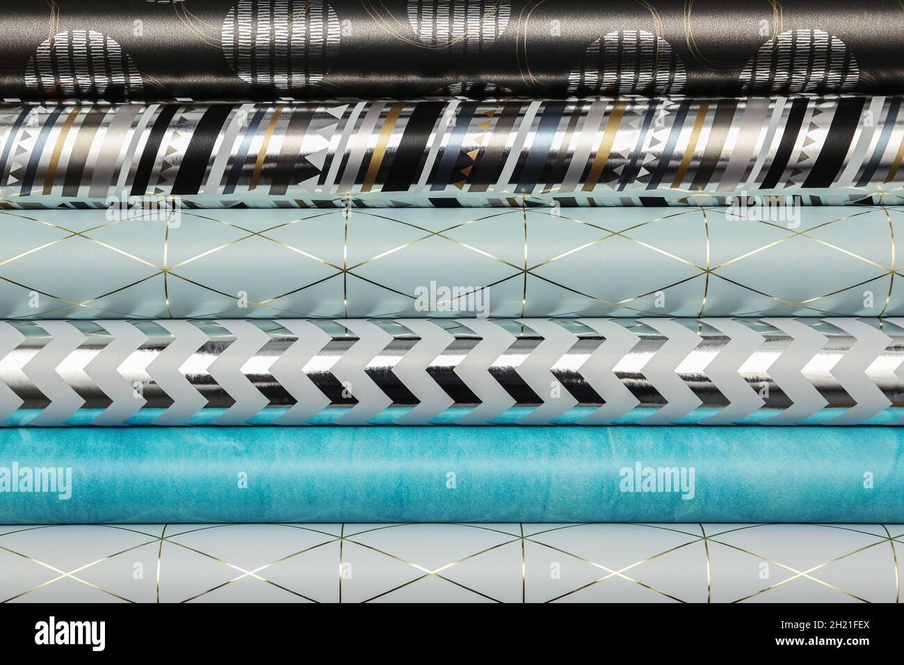 Rolls of festive wrapping paper as background, top view. Gift box ...