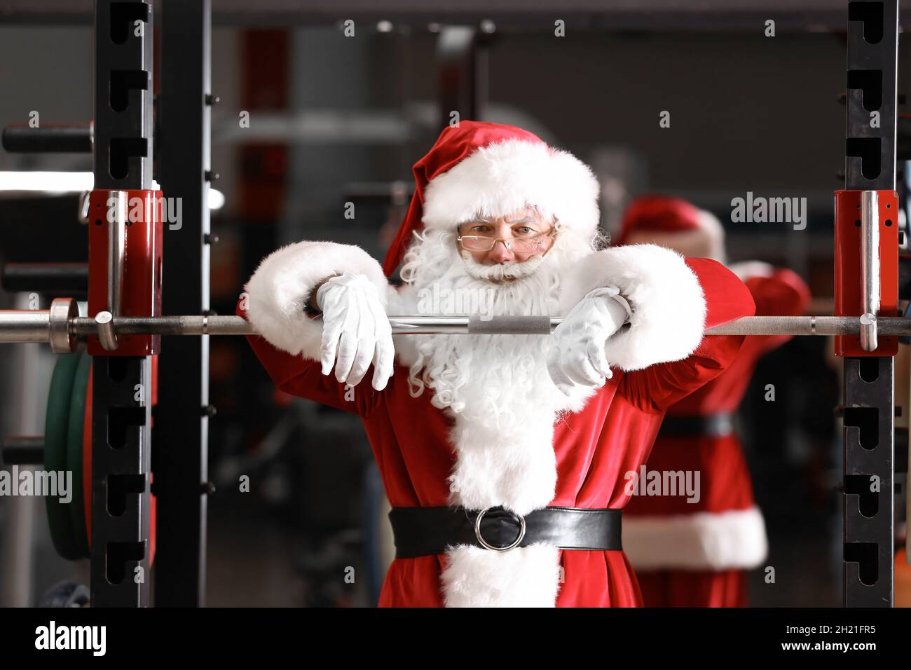 Authentic Santa Claus resting after exercise in modern gym Stock Photo ...