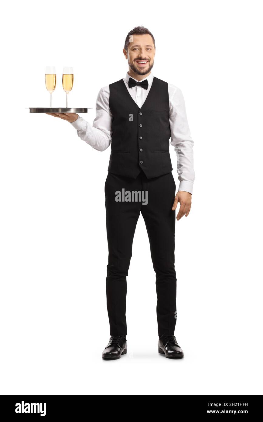 Full length portrait of a cheerful waiter holding a tray with glasses ...