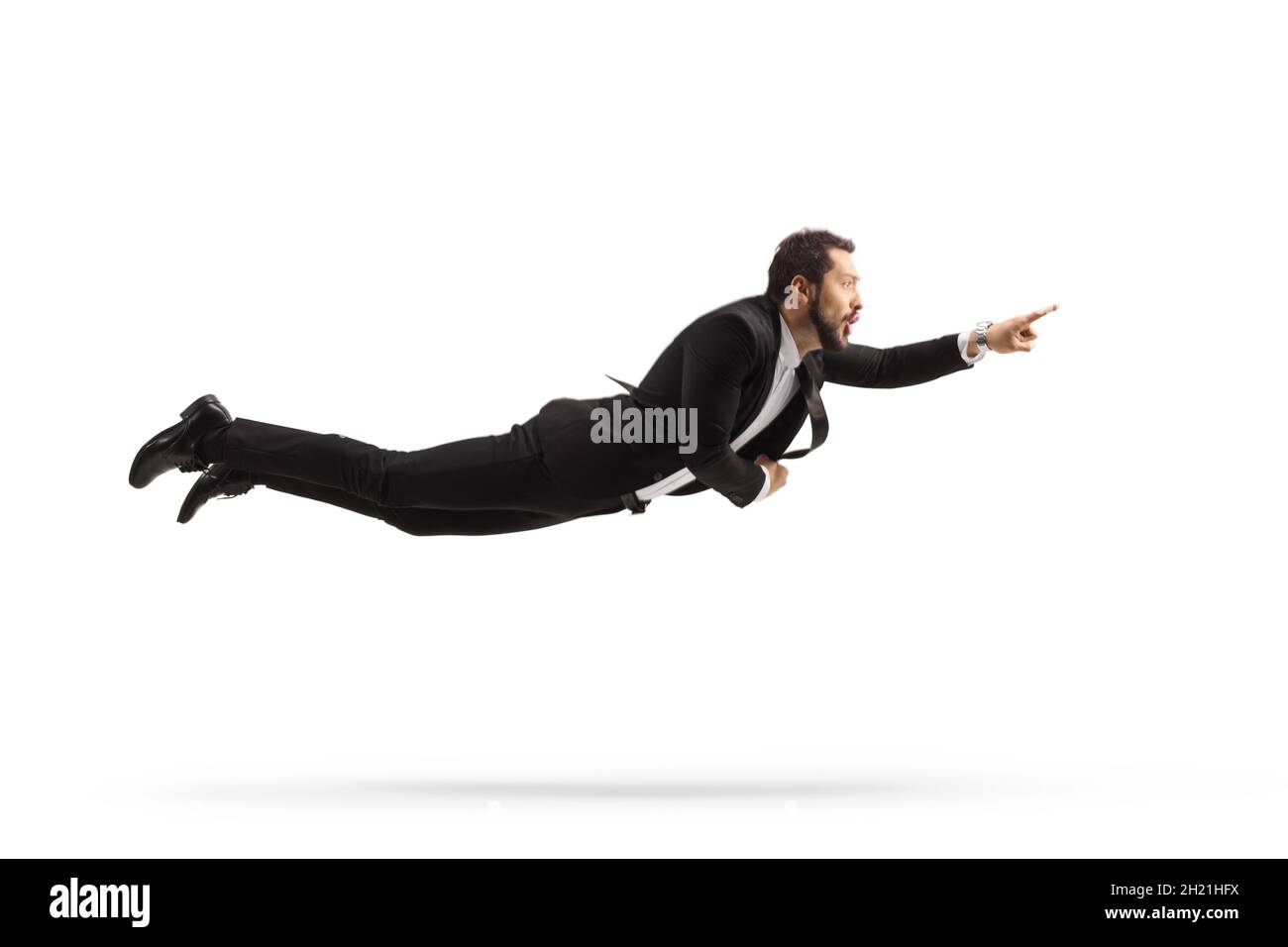 Full length profile shot of a businessman flying and pointing with ...