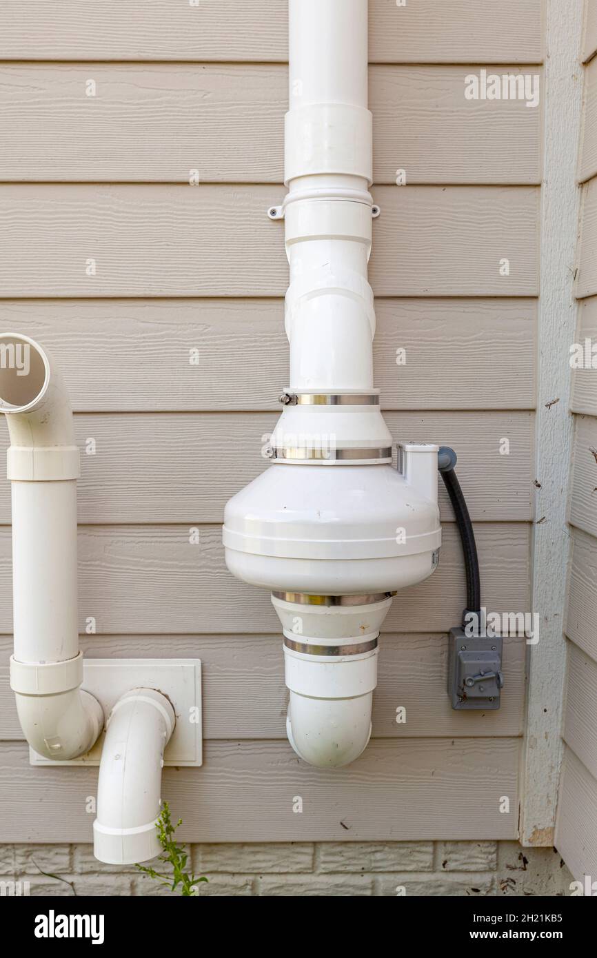 PVC pipes attached to the electrical motor of a residential radon ...