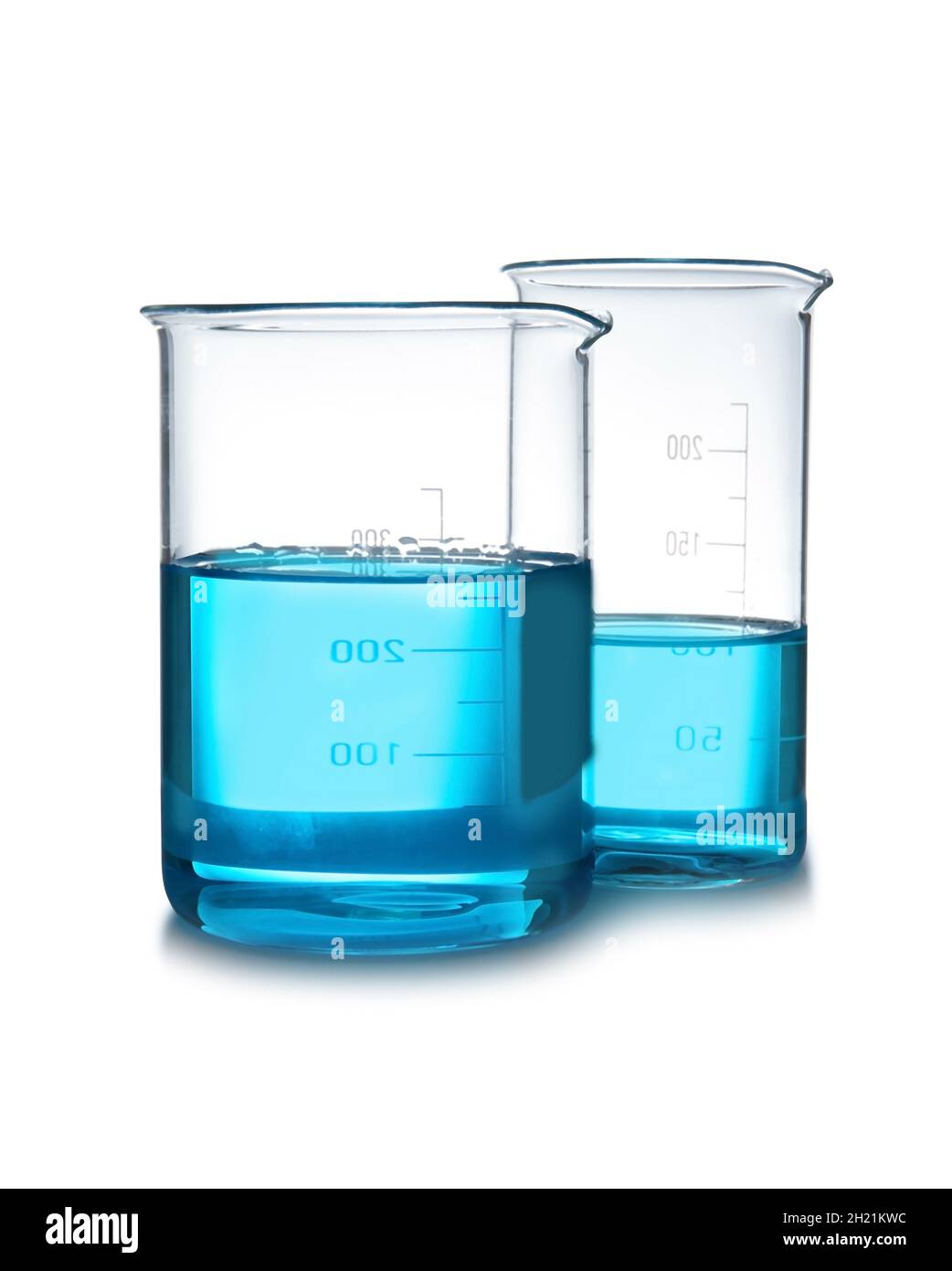 Beakers with liquid on table against white background. Laboratory ...