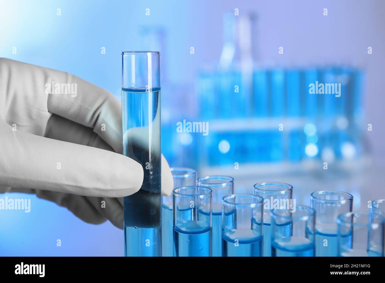 Scientist holding test tube with sample, closeup. Laboratory analysis ...