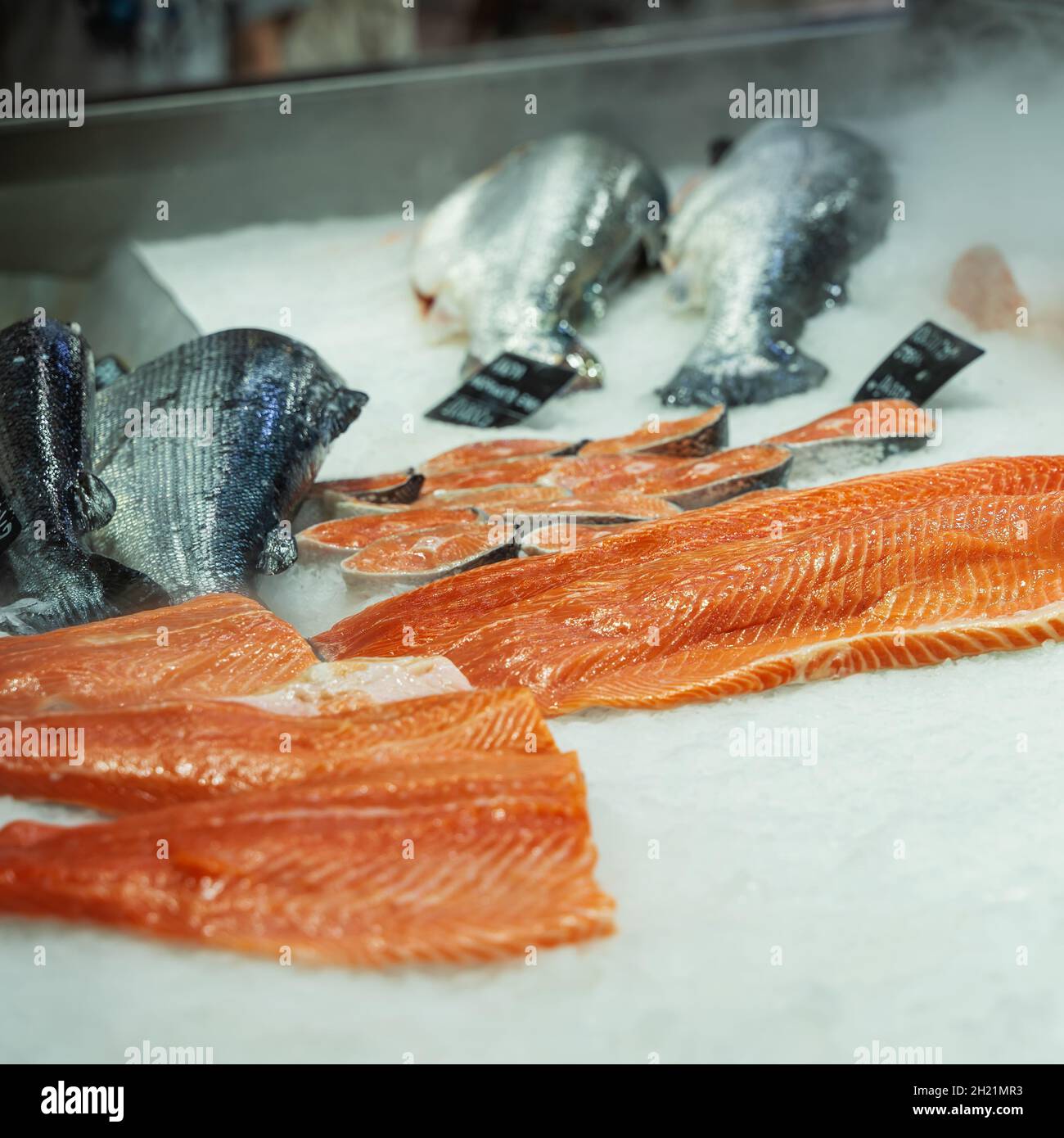 Fillet, slices and whole fresh fish on ice. Farmers seafood market ...