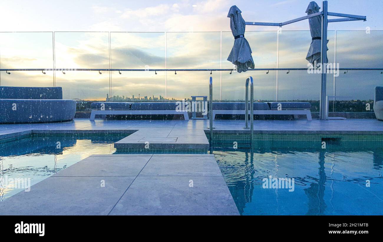 Swimming pool on a rooftop of a building in the evening Stock Photo - Alamy