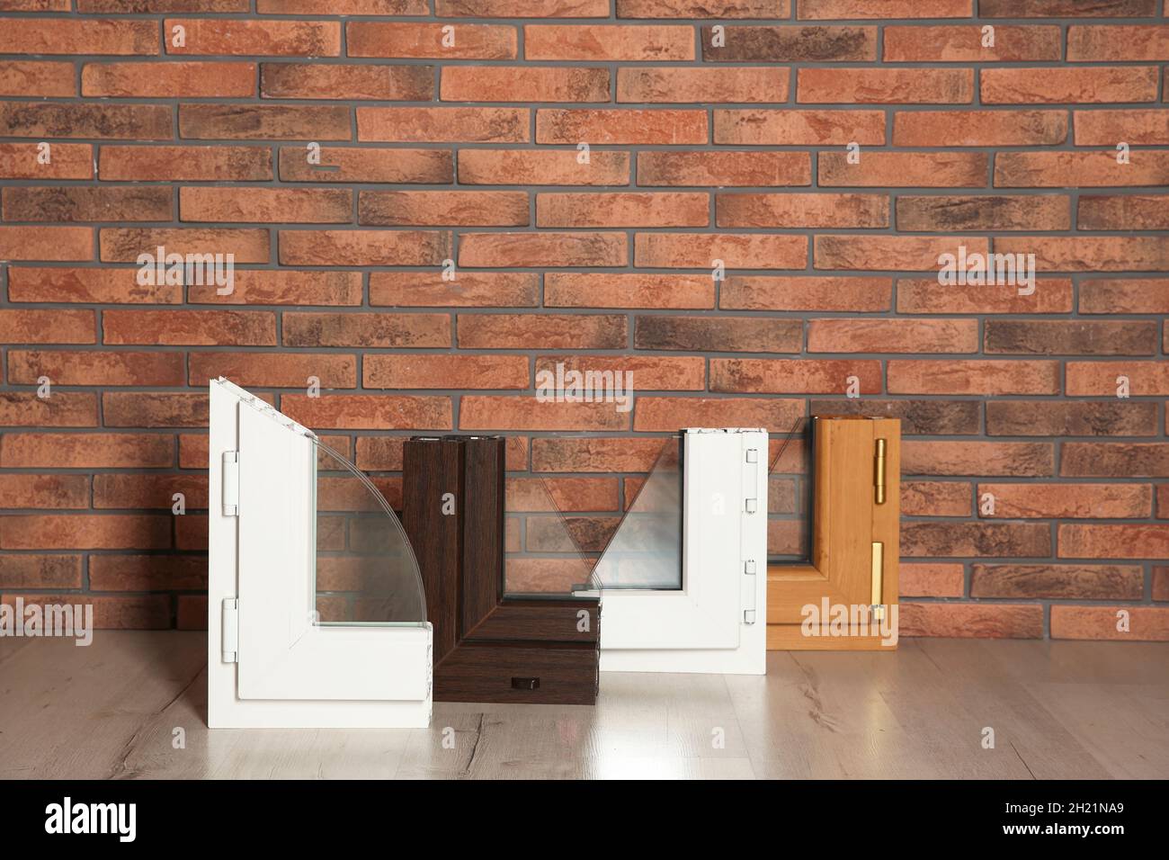 Samples of modern window profiles on floor against brick wall ...