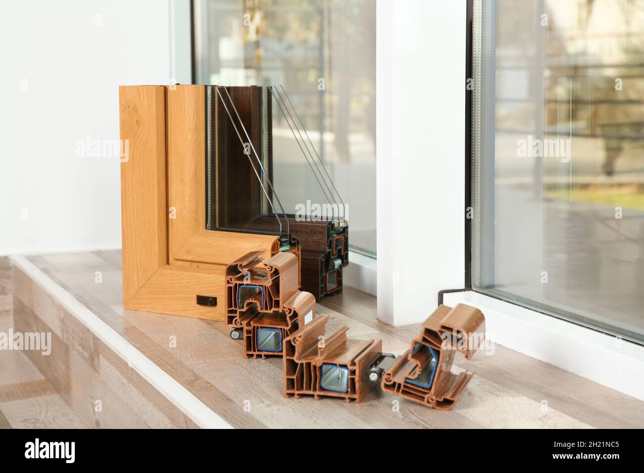 Samples of modern window profiles on sill indoors. Installation service ...