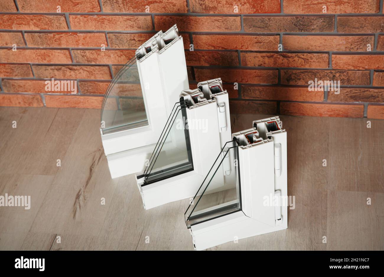 Samples of modern window profiles on floor against brick wall ...