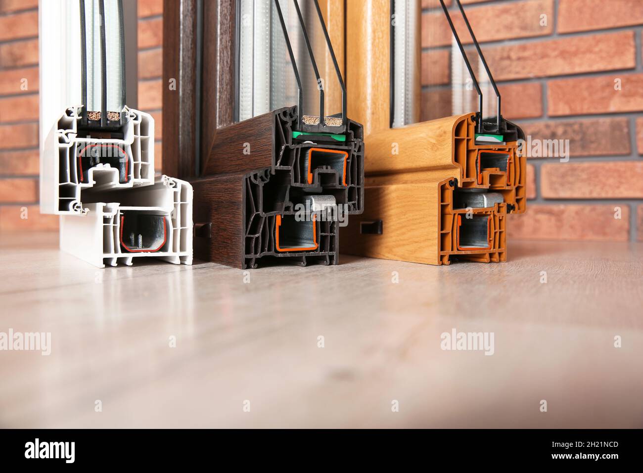 Samples of modern window profiles on floor against brick wall ...