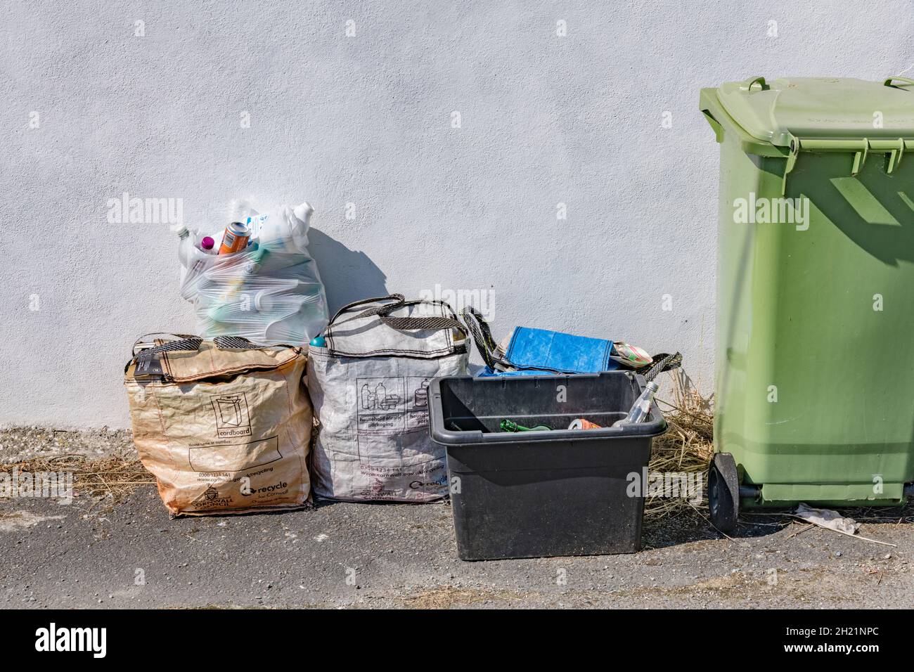Pile of weekly domestic rubbish outside rural house awaiting refuse ...