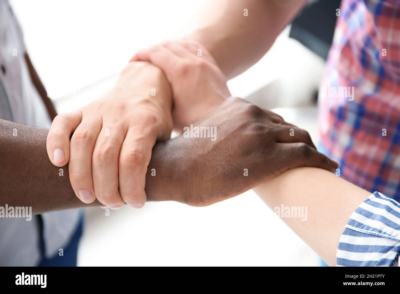 People holding hands on light background, closeup. Unity concept Stock ...