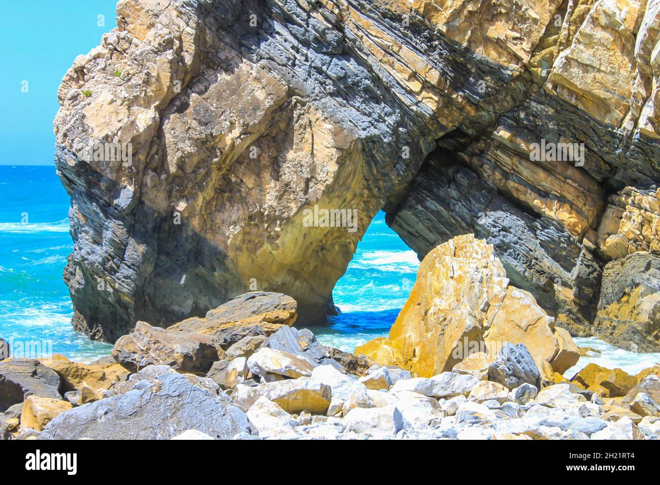 Beautiful shot of a big rock with geological formation in the ocean's ...