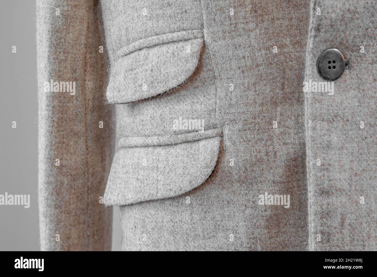 Side pockets on beige harris tweed bespoke suit Stock Photo - Alamy