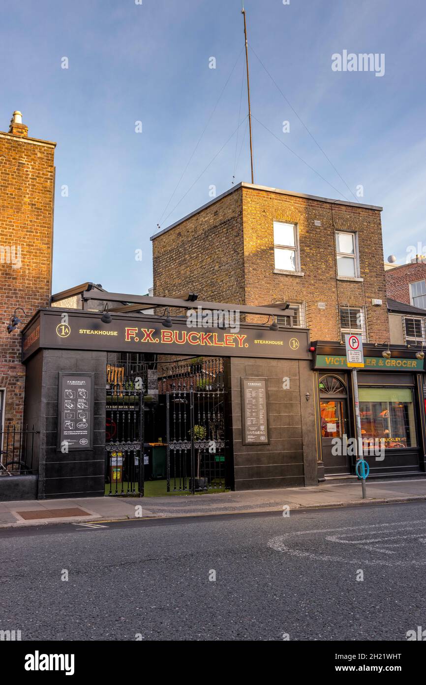 DUBLIN, IRELAND - Apr 23, 2021: A vertical shot of shops, restaurants ...