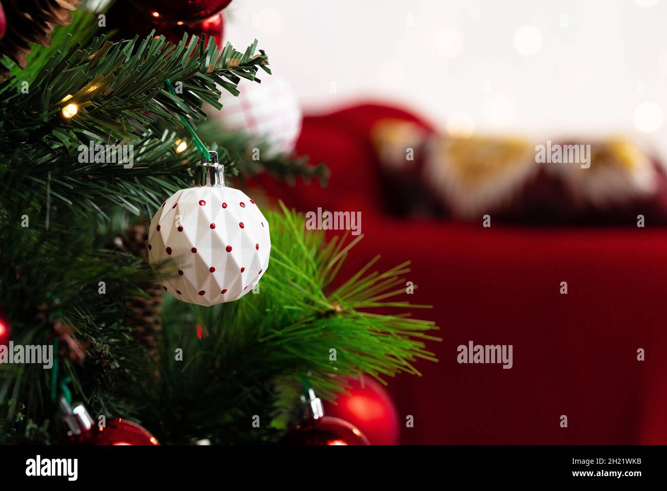 Red and white baubles hanging from a Christmas tree close up Stock ...