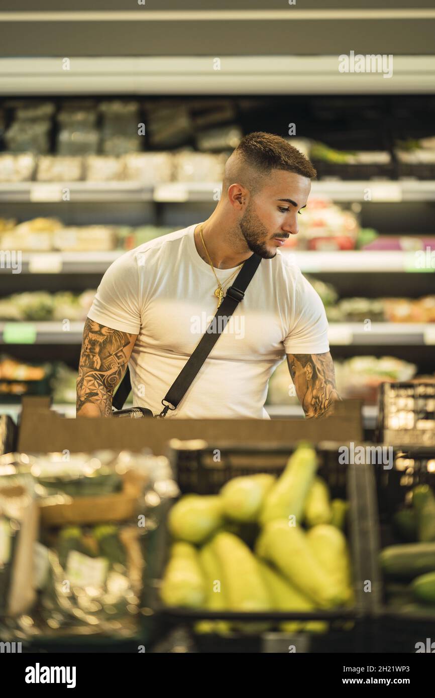Shallow focus shot of a guy shopping in the supermarket Stock Photo - Alamy