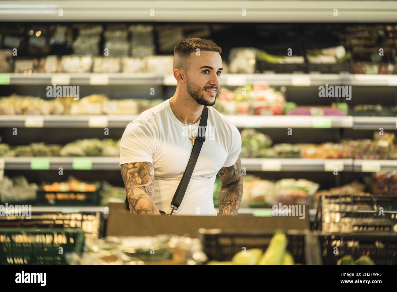 Horizontal shallow focus of a guy looking happily at something in the ...