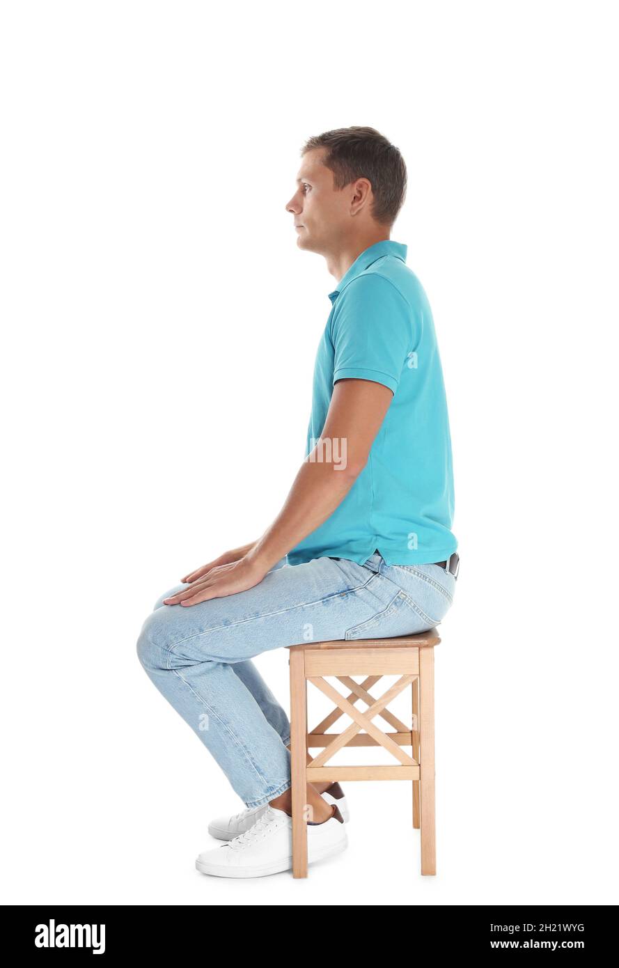 Man with good posture sitting on stool against white background Stock ...